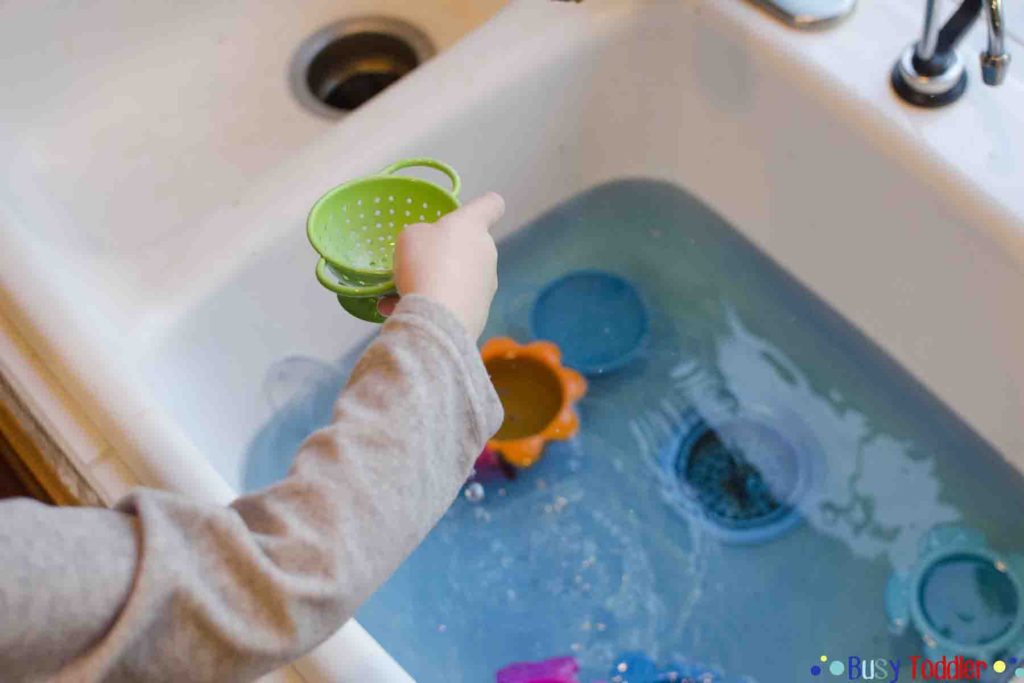 Colander Pour in the Kitchen Sink - Busy Toddler