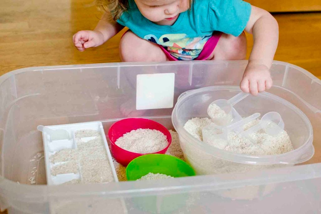 Scooping Rice Sensory Bin - Busy Toddler