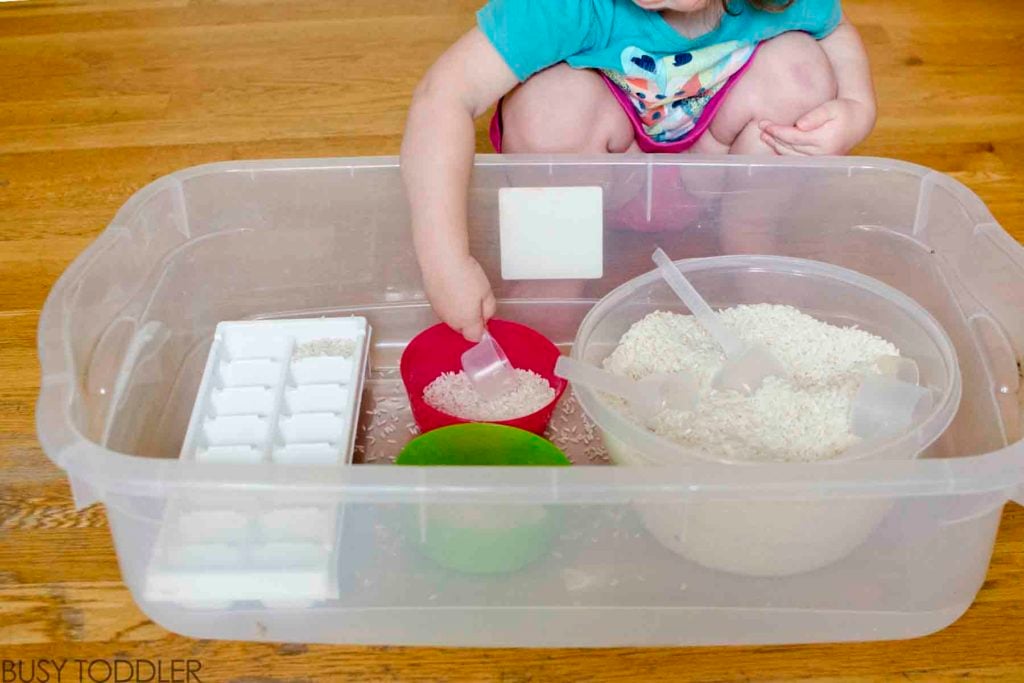 Scooping Rice Sensory Bin - Busy Toddler