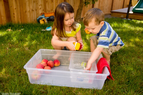 Apple Washing Bin Sensory Activity - Busy Toddler