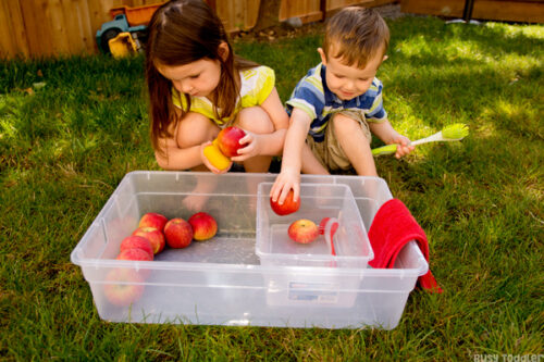 Apple Washing Bin Sensory Activity - Busy Toddler