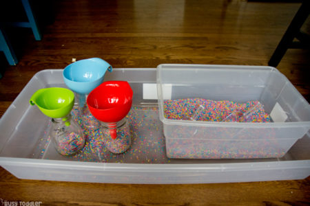 Funnels and Rice: A Perfect Sensory Bin - Busy Toddler
