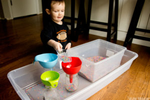 Funnels and Rice: A Perfect Sensory Bin - Busy Toddler
