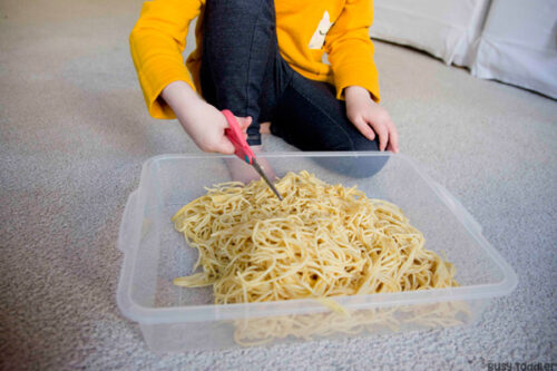 Spaghetti Cutting Bin - Scissor Skills Activity - Busy Toddler