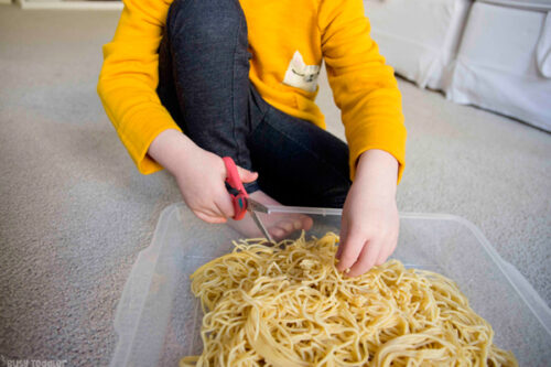 Spaghetti Cutting Bin - Scissor Skills Activity - Busy Toddler