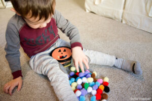 Feed the Pumpkin Halloween Toddler Activity - Busy Toddler