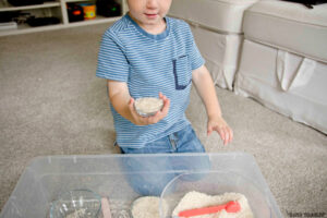 Rice Bin Toddler Activity: Scoop and Transfer - Busy Toddler