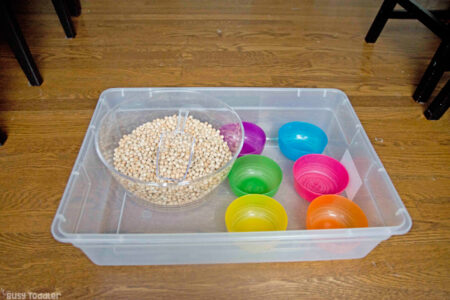 Toddler Scooping Activity with Garbanzo Beans - Busy Toddler