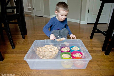 Toddler Scooping Activity with Garbanzo Beans - Busy Toddler