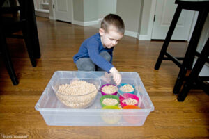 Toddler Scooping Activity with Garbanzo Beans - Busy Toddler