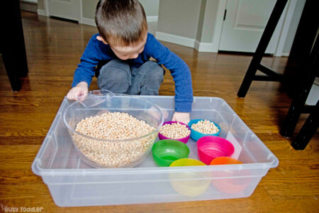 Toddler Scooping Activity with Garbanzo Beans - Busy Toddler