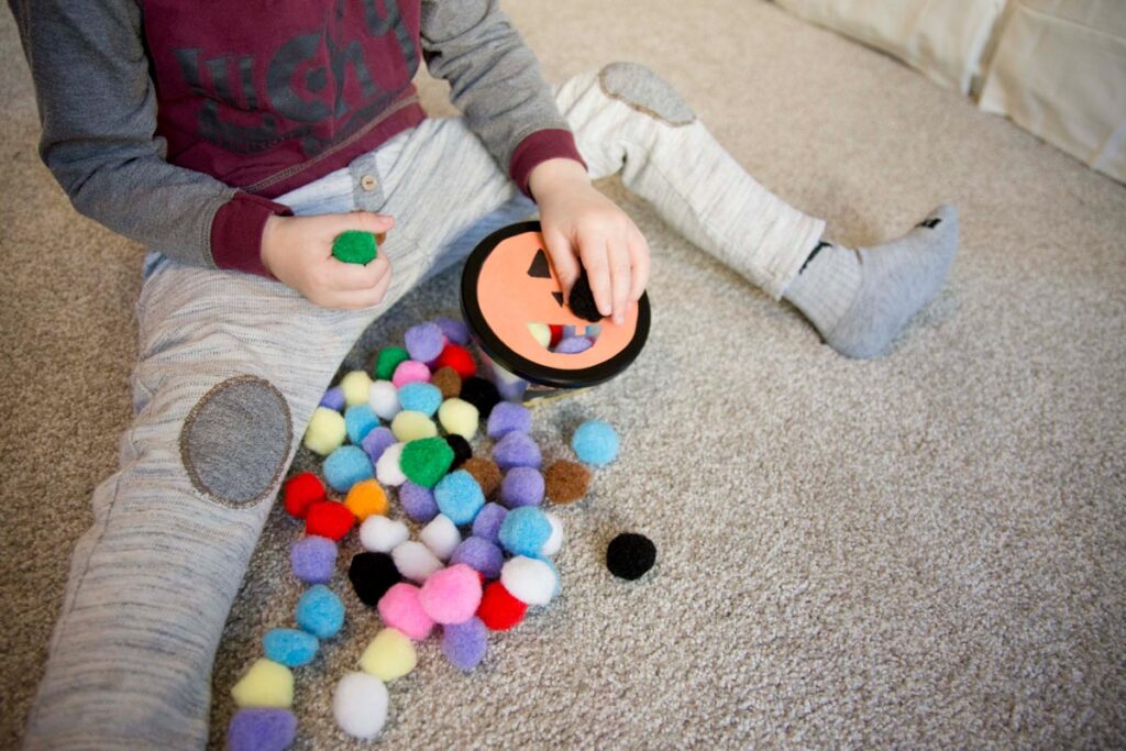 Feed the Pumpkin Halloween Toddler Activity - Busy Toddler